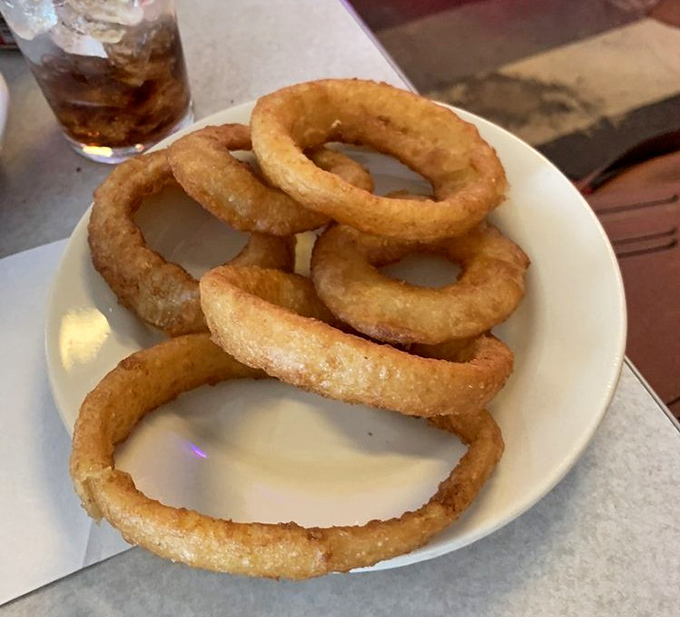 Onion rings that achieve the perfect balance &ndash; substantial enough to satisfy, yet light enough that you don't feel like you're wearing them home.