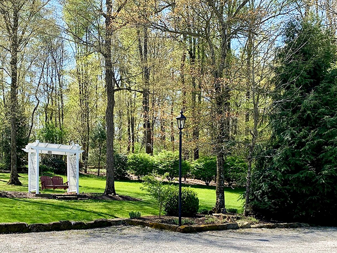 A garden arbor invites contemplation among spring blooms. Here's where you realize your backyard "oasis" back home is just a sad patio with delusions of grandeur.