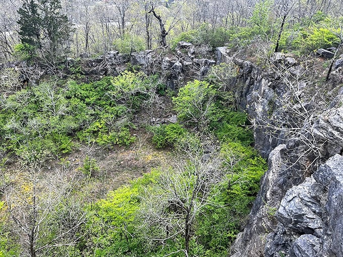 The earth literally opens up before you, revealing a hidden quarry where time has carved its signature into stone over millions of years.