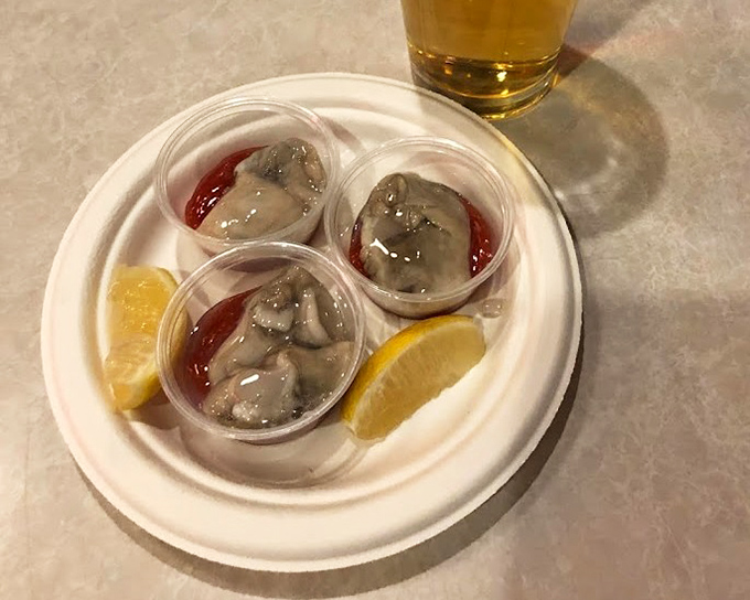 Fresh oysters served simply with cocktail sauce and lemon wedges. Sometimes the ocean's finest needs nothing more than a squeeze of citrus.