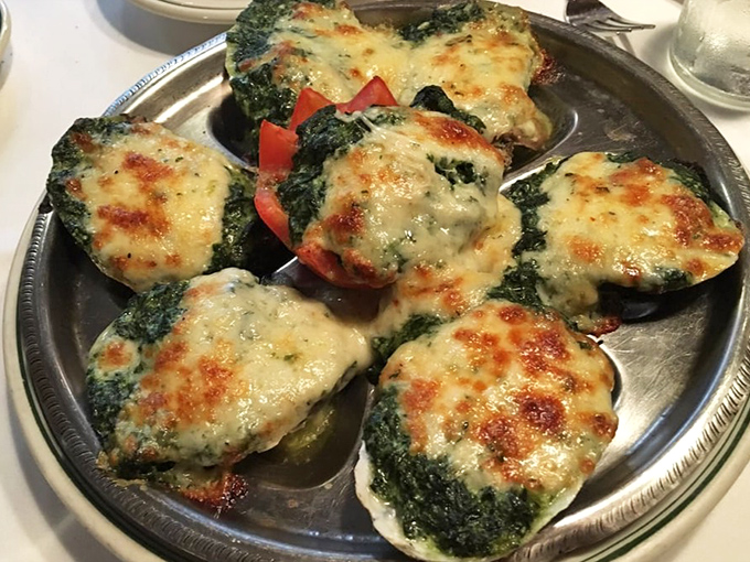 Oysters Rockefeller looking like little jewels of the sea, their spinach-cheese topping bubbling to golden perfection on a silver platter.