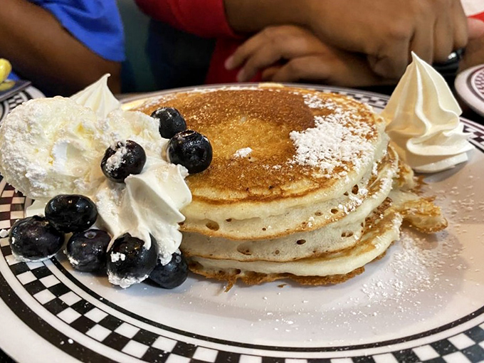 Pancakes stacked high with whipped cream and blueberries&mdash;because sometimes breakfast should look like it's celebrating something, even if that something is just Tuesday.