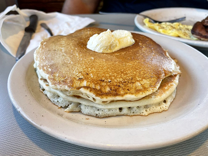 Pancakes that achieve the impossible trifecta: golden exterior, fluffy interior, and sturdy enough to support a proper butter hat.