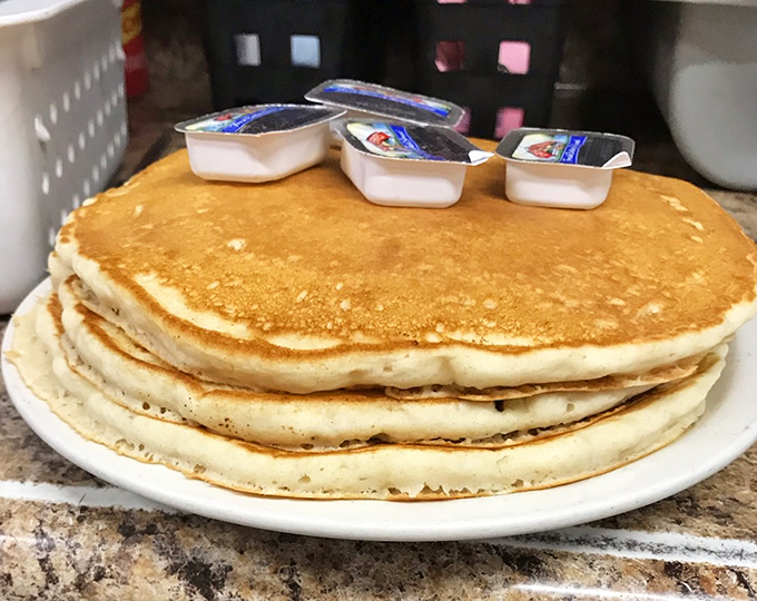 Pancakes stacked higher than your weekend plans, golden-edged and waiting for that maple syrup waterfall. Breakfast of champions.