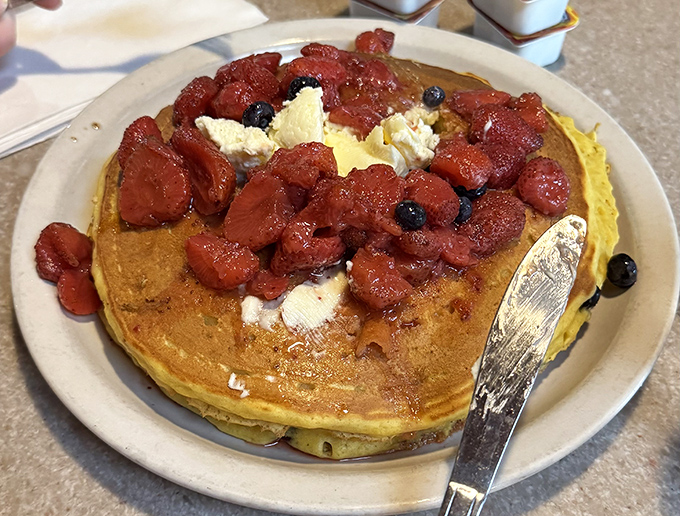 Pancakes crowned with fresh berries and butter—breakfast royalty that commands respect. One bite and you'll understand why people make pilgrimages to this Kenosha landmark.