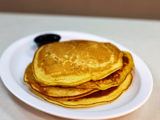 Golden pancakes stacked with military precision&mdash;the kind that make you wonder why brunch became fancy when this perfection exists.