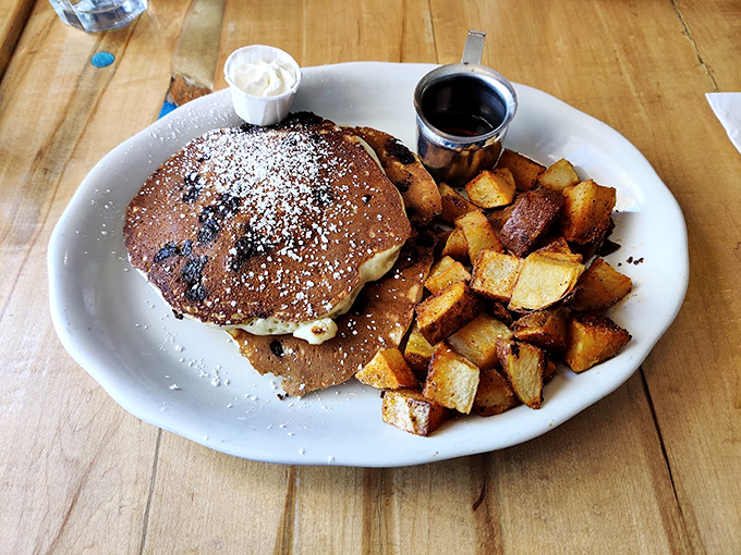 Pancakes that deserve their own ZIP code. Dusted with powdered sugar and served with golden home fries&mdash;this plate is Vermont's answer to breakfast bliss.