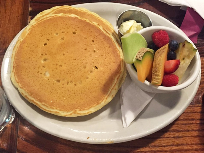 The pancake that launched a thousand road trips. Served with fresh fruit that makes you feel virtuous while committing delicious breakfast crimes. 