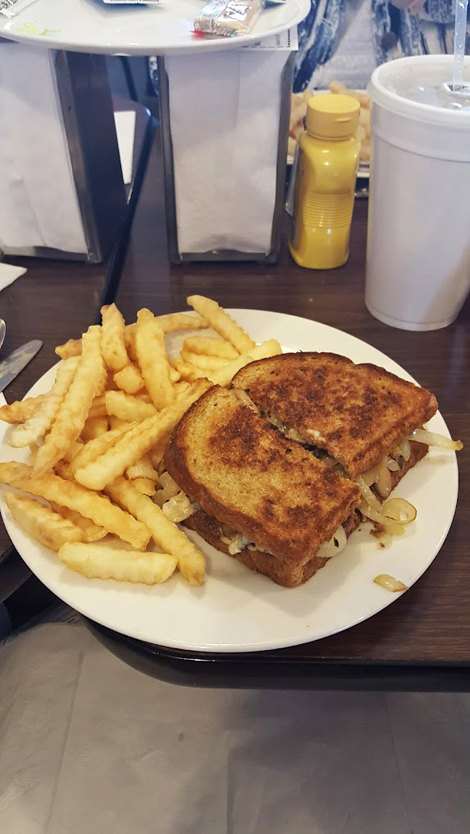 The patty melt: where grilled bread, caramelized onions, and beef unite in harmony. Paired with those crinkle-cut fries, it's the lunch of champions.