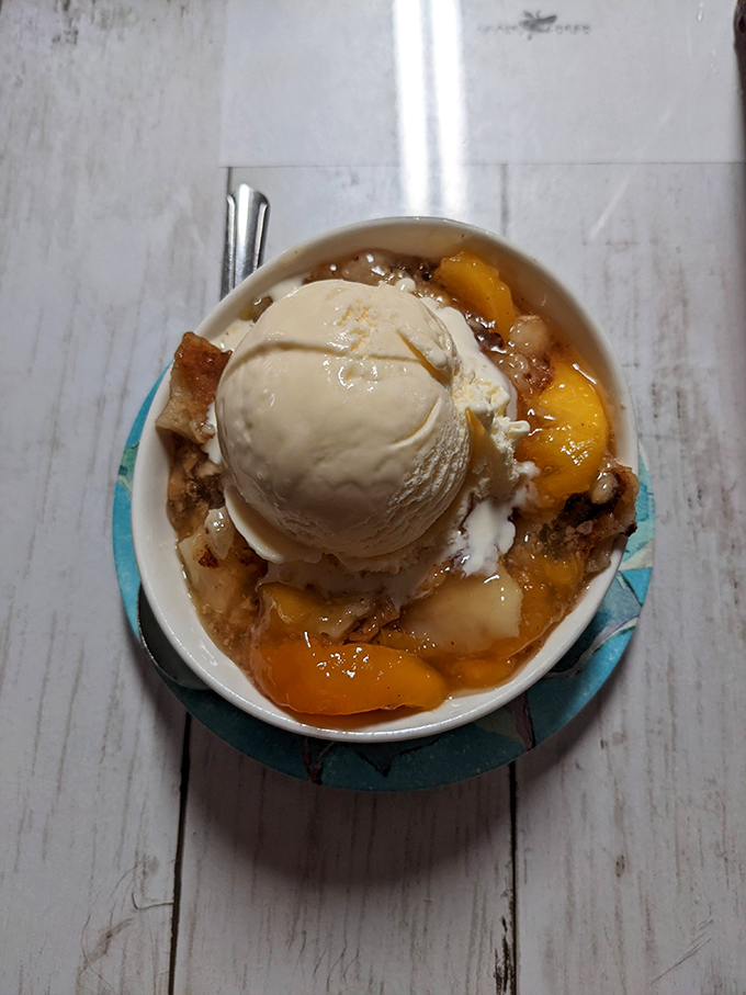 Peach cobbler topped with ice cream: because apparently someone decided dessert needed to win at life today.