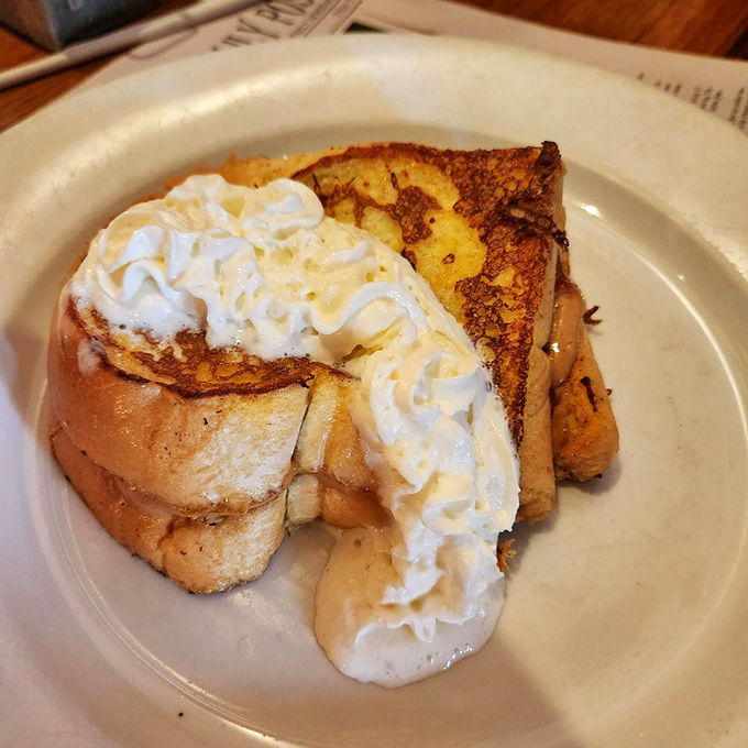 French toast stuffed with peanut butter and topped with whipped cream&mdash;childhood dreams all grown up and living their best life on a plate.