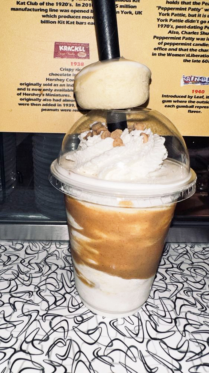 Behind this shake's caramel swirls lies a history lesson in candy evolution, displayed on vintage-inspired wallpaper that doubles as conversation starter.