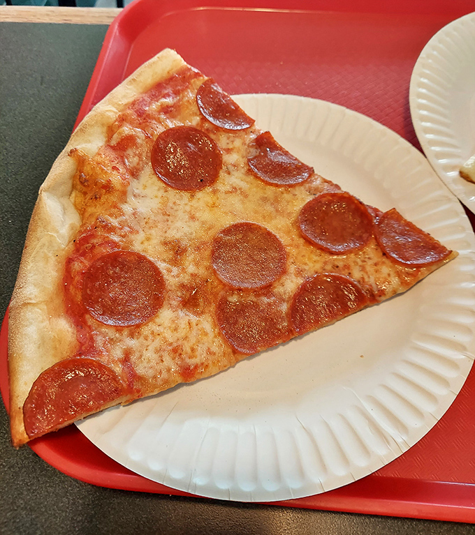 The pepperoni slice that launched a thousand cravings—perfectly curled cups of spicy goodness on a canvas of melted cheese and tangy sauce.