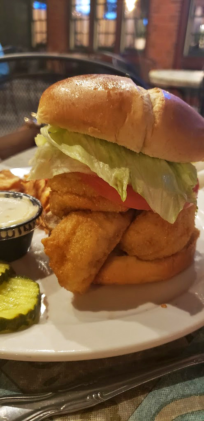 This perch sandwich isn't just food&mdash;it's architecture. Golden-battered fish stacked high with fresh toppings on a pillowy bun.