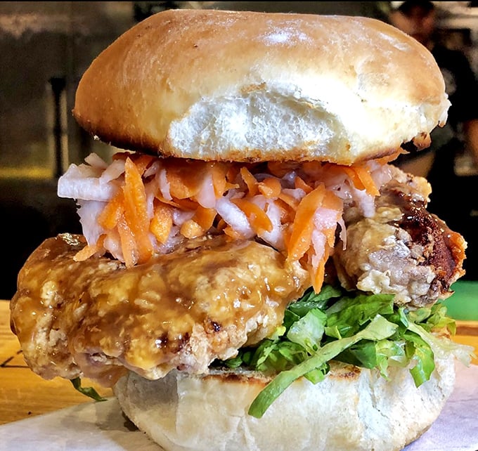 When a Peruvian-style sandwich requires this much napkin real estate, you know you're in for something special. The glistening sauce and perfect bun promise a gloriously messy affair.