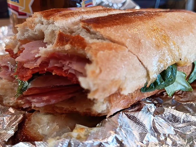 That cross-section reveals layers of Italian meats and vegetables tucked into bread that's been toasted to golden perfection.