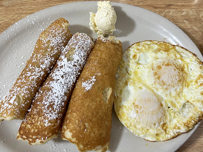 French toast dusted with powdered sugar like a New Mexico winter morning, served with an egg cooked exactly how you want it&mdash;breakfast harmony on a plate.