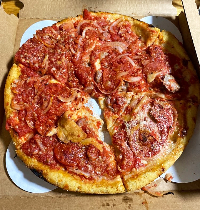 This isn't just pizza &ndash; it's a butter-crusted pan masterpiece that makes deep dish devotees question their allegiances. Those caramelized edges don't lie.