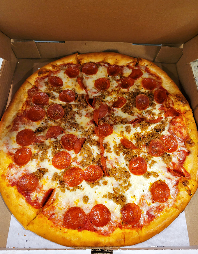Pizza perfection in a box: a golden crust supporting the delicate balance of tangy sauce, melted cheese, and pepperoni that curls into little flavor cups.