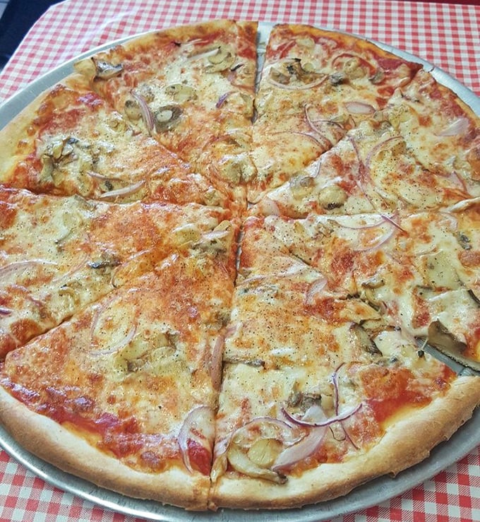 Pizza perfection doesn't need to shout. This thin-crust masterpiece with delicate onions and herbs whispers "I've been doing this right for decades."