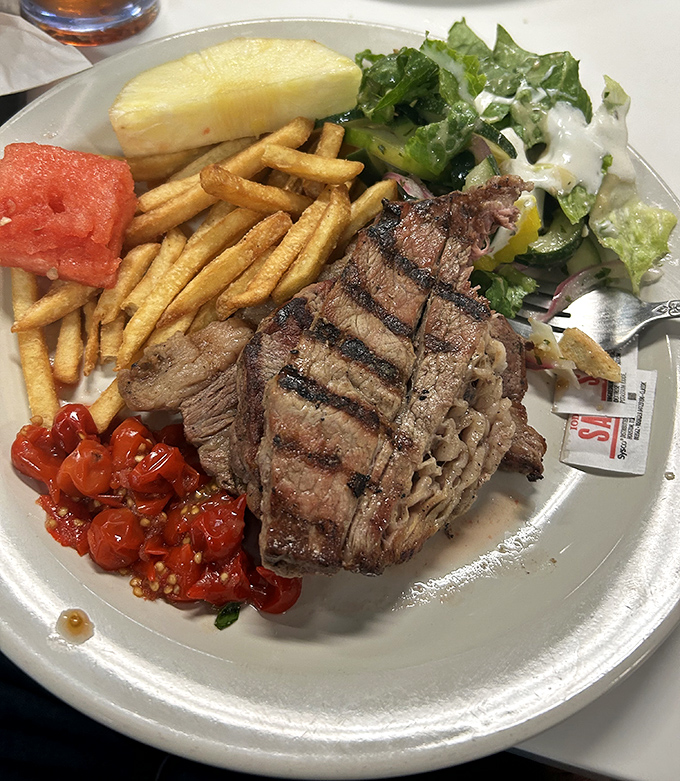 Grilled steak with fresh sides&mdash;proof that sometimes the simplest combinations create the most profound food memories.