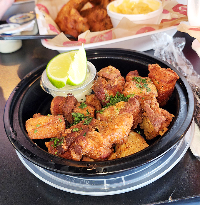 Crispy nuggets of flavor-packed chicken with a lime wedge standing by for emergency relief. The garnish of fresh herbs adds a touch of color to this spice festival.