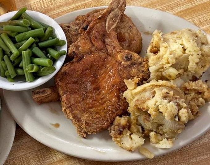 When a pork chop is cooked this perfectly, with stuffing that steals half the show, you understand why some people drive hours for dinner.