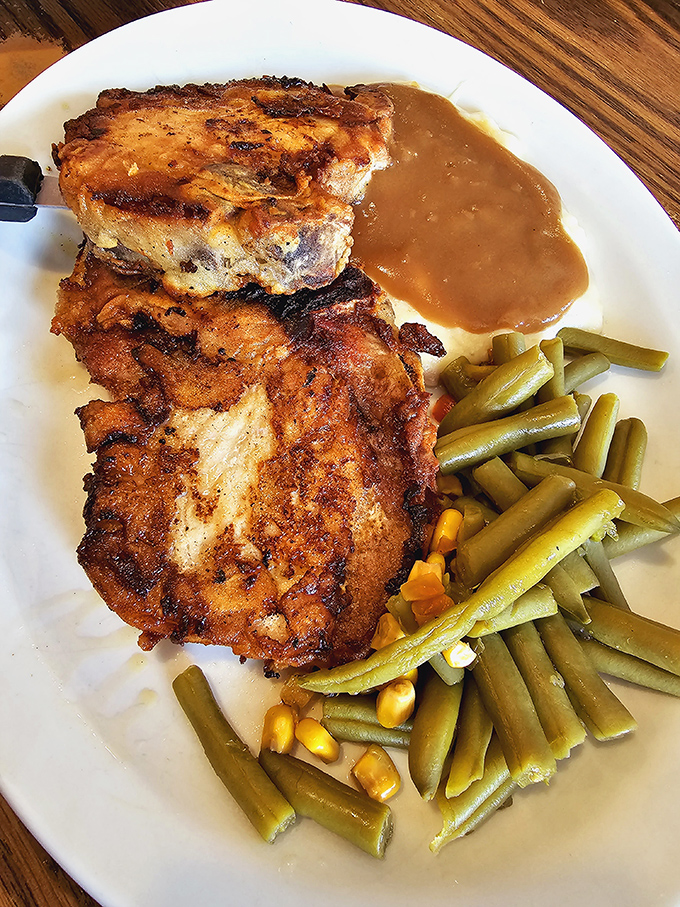 These pork chops aren't just dinner; they're a statement. Golden-brown, gravy-kissed perfection that would make your grandmother both proud and jealous.