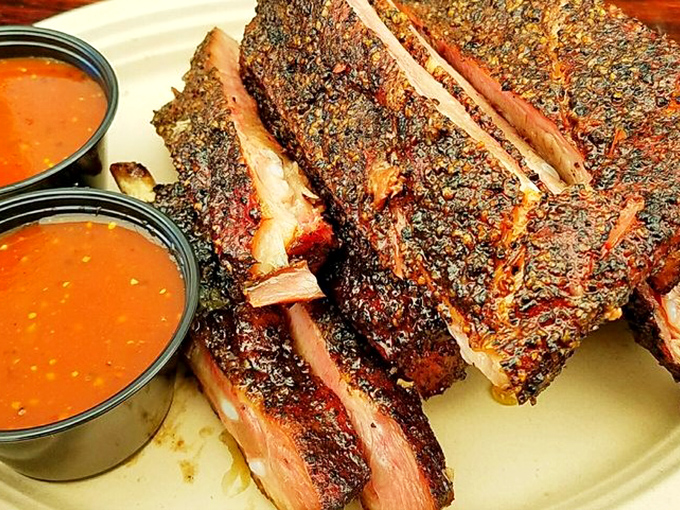 Pork ribs with a bark so perfect it deserves its own Instagram account. The sauce cups are just there for show.