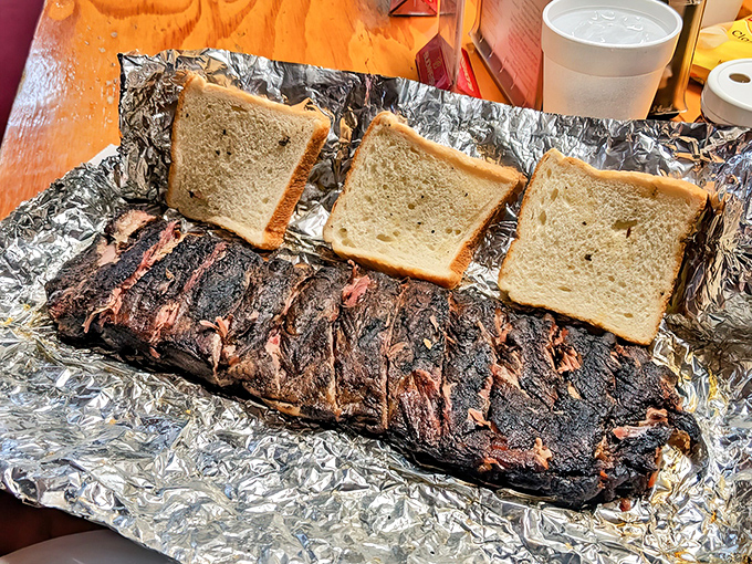 Three slices of white bread stand guard over these ribs like sentinels of simplicity. The perfect tools for sopping up every last drop.