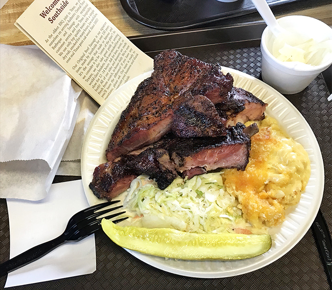 A plate that speaks the universal language of Texas &ndash; smoked meat, mac and cheese, coleslaw, and a pickle spear for that perfect acidic counterpoint.