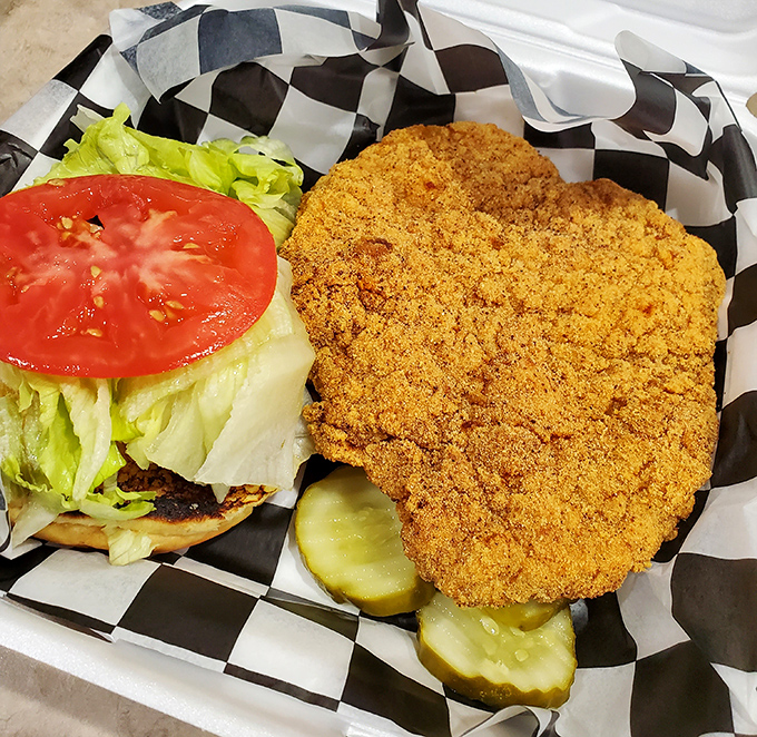 A breaded pork tenderloin that's having an identity crisis as it tries to escape the boundaries of its bun. Pure Hoosier happiness!
