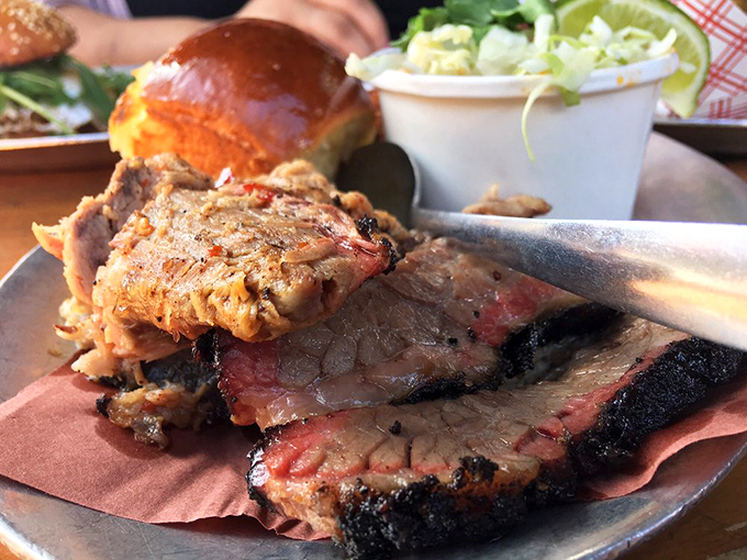 Meat displayed with the reverence it deserves. Tender pork shoulder and smoky brisket share the plate, their bark a badge of honor from the pitmaster’s school of slow and steady.