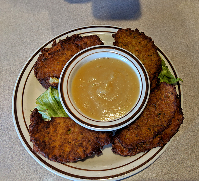 Golden-brown potato pancakes that crunch louder than your dad in the pantry at midnight. The applesauce sidekick is non-negotiable.