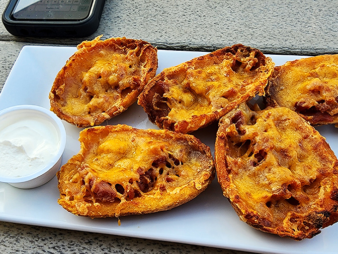 Potato skins: where humble spuds are transformed into crispy vessels of melted cheese and bacon&mdash;proof that simple pleasures are often the most satisfying.