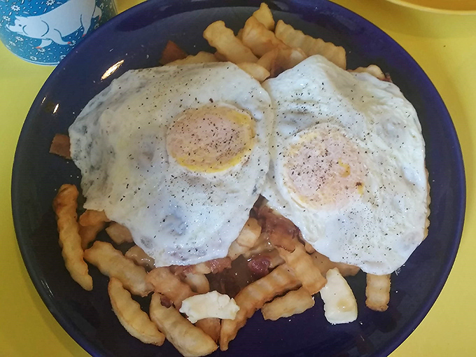 Breakfast rebellion at its finest&mdash;crispy fries topped with eggs and what appears to be breakfast meats create a morning poutine worth waking up for.