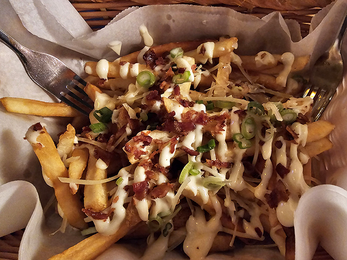 Loaded fries that laugh in the face of moderation, where bacon, cheese, and green onions throw a party on a bed of crispy potatoes.