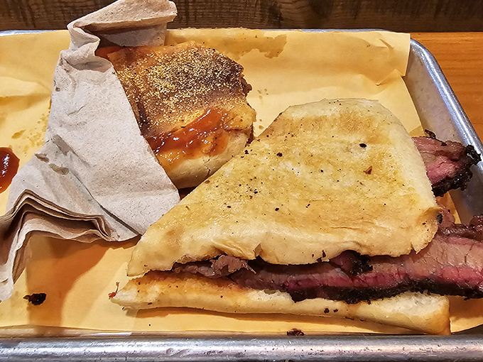 The pressed brisket po'boy – where Louisiana tradition meets Texas technique in a sandwich that bridges culinary borders beautifully.