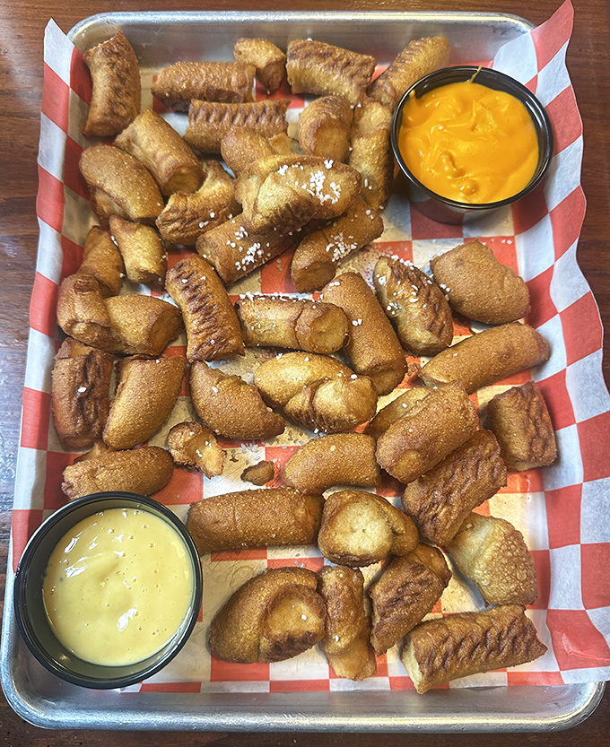 Pretzel bites that achieve that magical balance of crispy exterior and soft interior, served with dipping sauces that'll have you plotting your next visit before you've finished the first one.