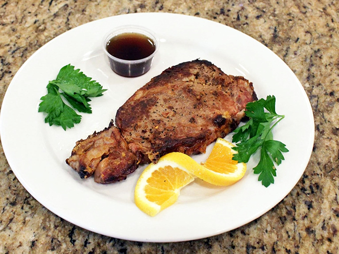 Prime rib that's dressed for success with a side of au jus and garnish. Meat this good doesn't need a fancy introduction—just a sharp knife.