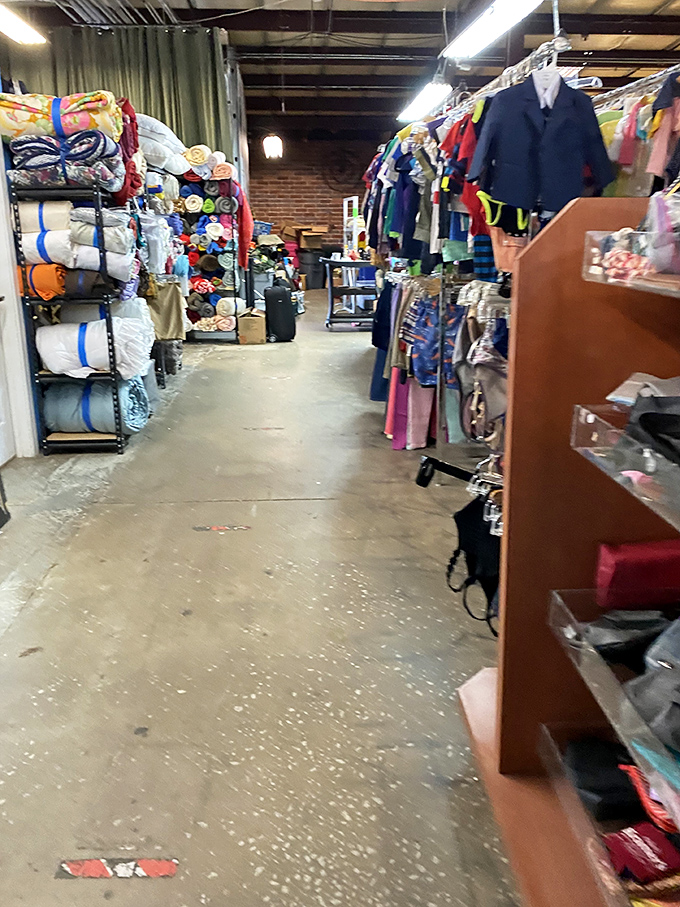 Navigate aisles of organized treasures where bedding, clothing, and possibilities line both sides of this thrifter's yellow brick road.