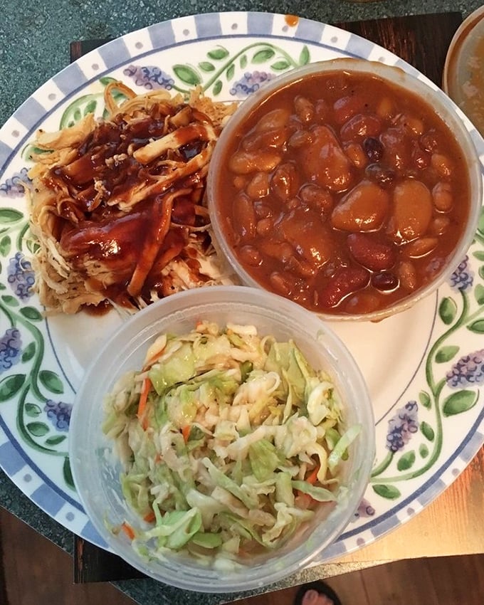 A plate that tells a story of patience&mdash;pulled chicken, beans, and slaw creating the holy trinity of barbecue satisfaction.
