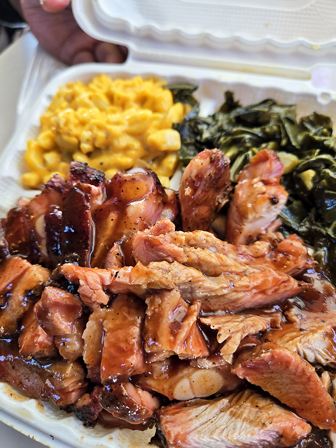 Pulled pork that's had a proper introduction to smoke, paired with mac and cheese and greens&mdash;the holy trinity of barbecue companionship.