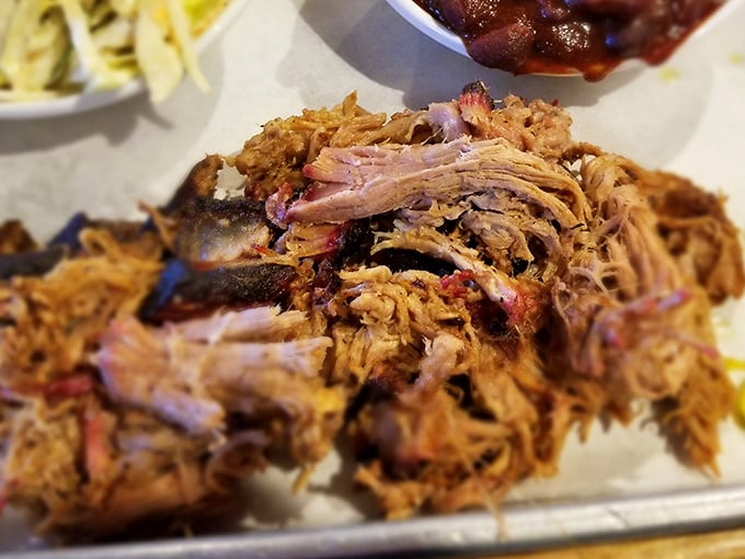 Pulled pork that's been coaxed, not forced, into submission. Each strand carries the perfect balance of smoke, spice, and porcine perfection.
