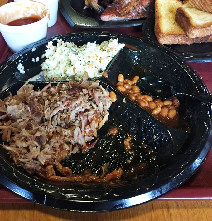 The barbecue trinity: pulled pork, creamy slaw, and baked beans—a holy alliance that's converted more food skeptics than any religion.