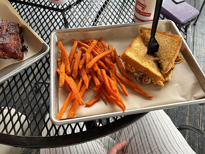 The humble sweet potato fry escorts a pulled pork sandwich to your table, a Mississippi power couple that never disappoints.