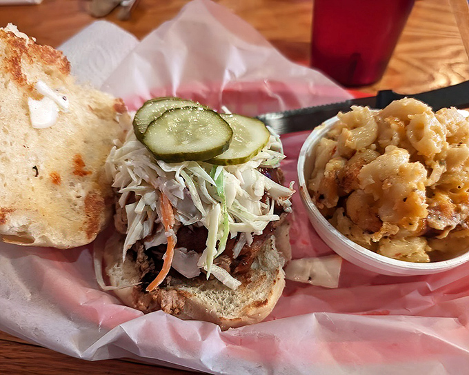 This pulled pork sandwich, topped with slaw and pickles, isn't just lunch—it's an edible hug. The side of mac and cheese seals the deal.
