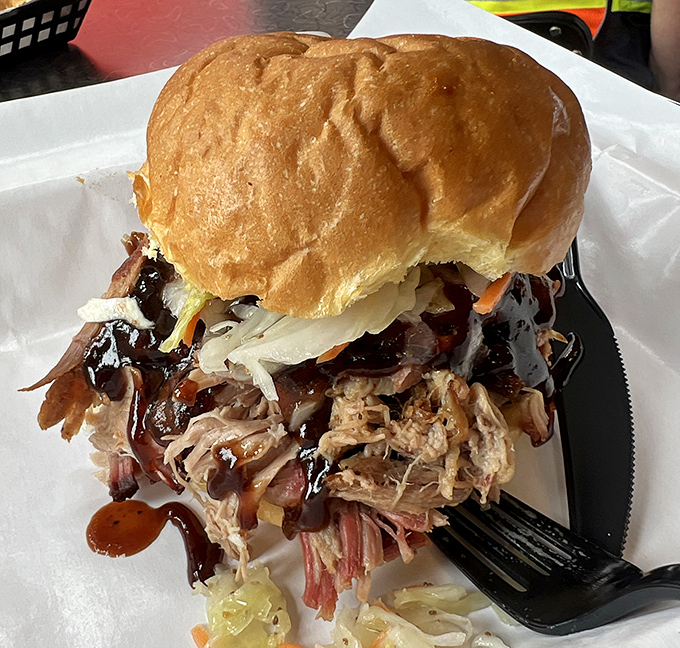 This pulled pork sandwich isn't just a meal&mdash;it's an architectural marvel of smoke-kissed pork, tangy slaw, and sauce, all balanced on a perfectly soft bun.