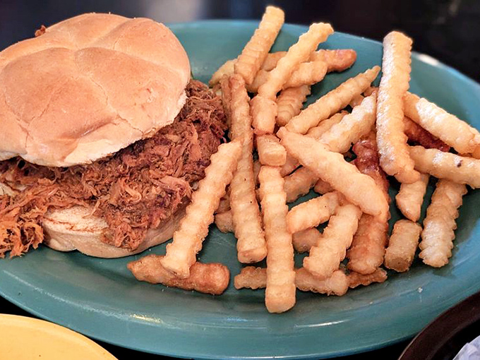 A sandwich that requires both hands and a strategy. The pulled pork practically surrenders to your first bite.