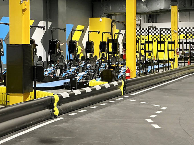 The starting line awaits at this sleek go-kart track, where the checkered flag dreams of weekend warriors come to life under industrial lighting.